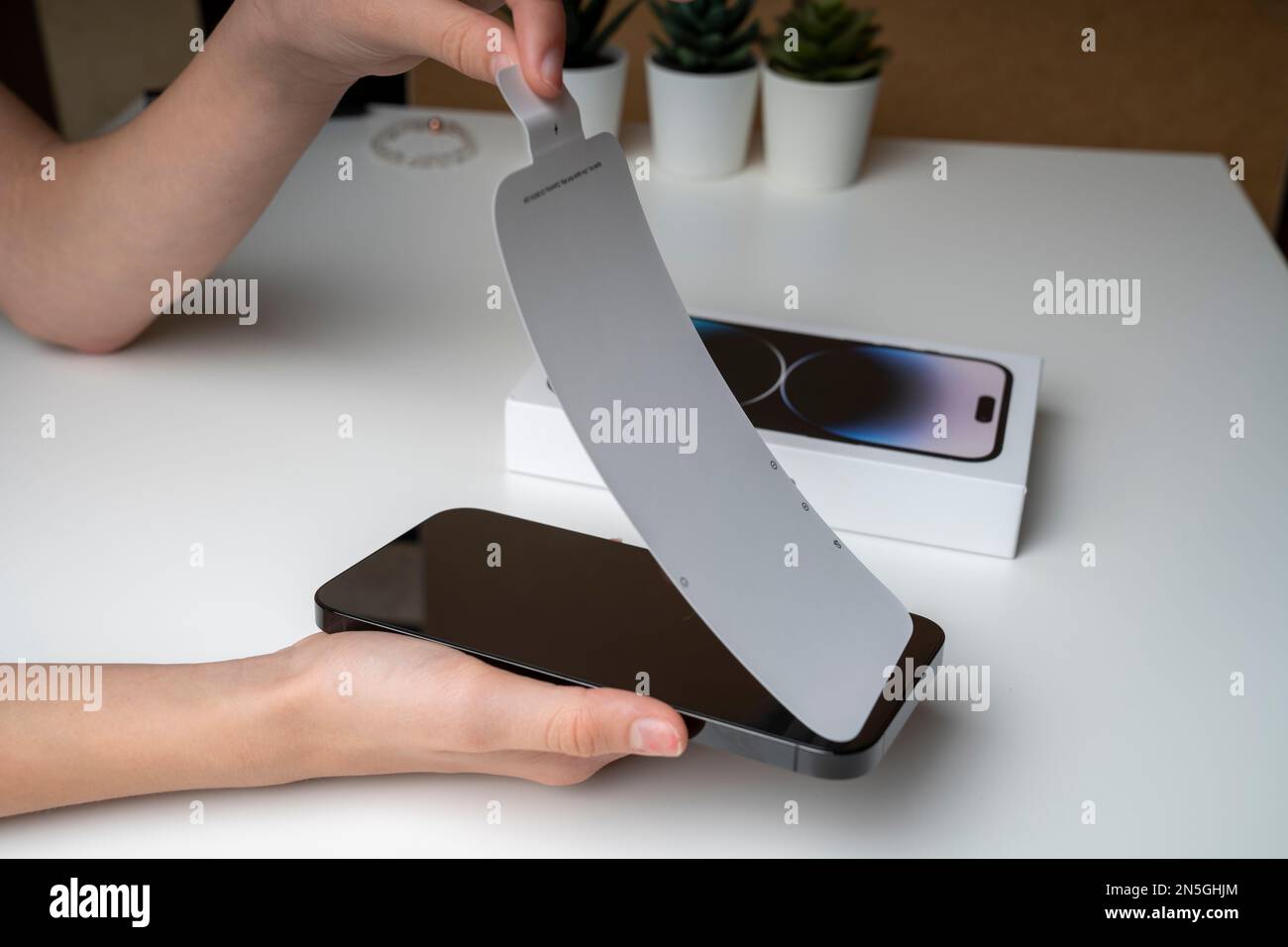 A girl holds the latest iPhone 14 Pro Max, Space Black. Apple's latest ...