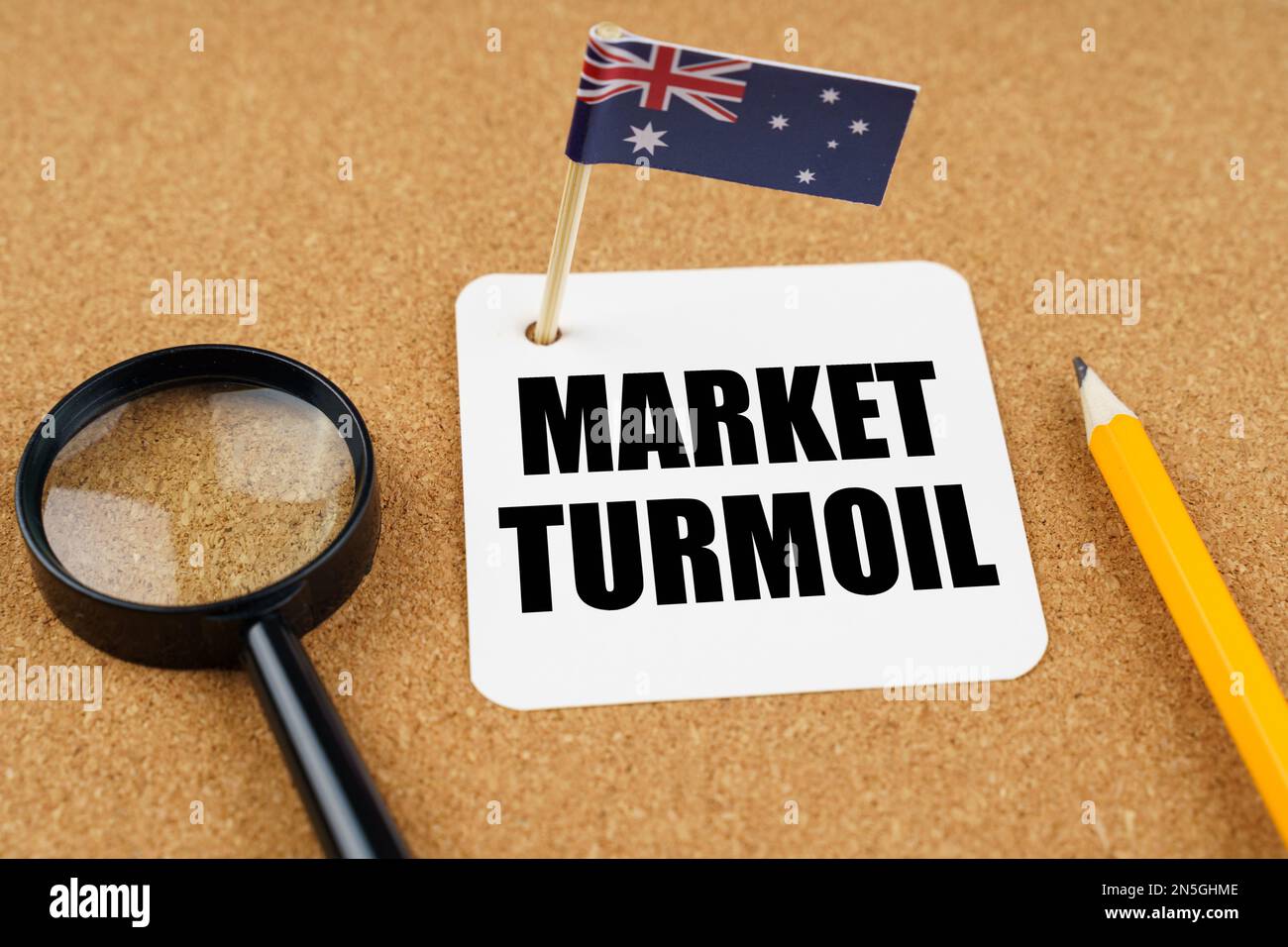 On the table is the flag of Australia, a pencil, a magnifying glass and ...