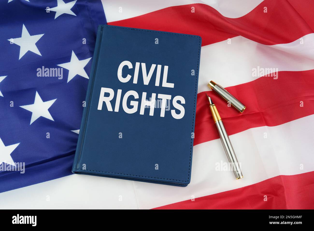 Law concept. On the US flag lies a pen and a book with the inscription ...
