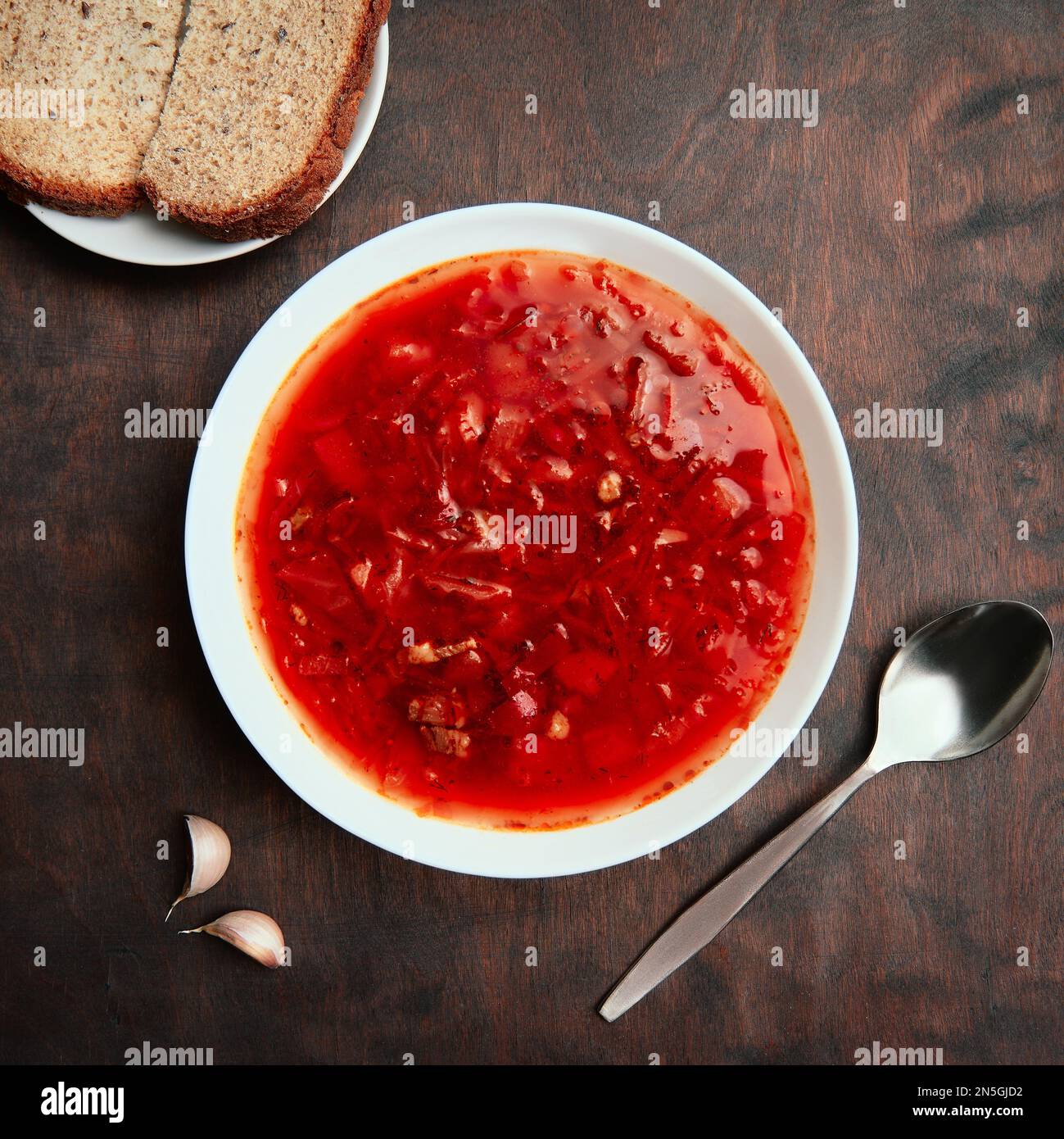 Borsch in plate on rough wooden table, a traditional Russian and ...