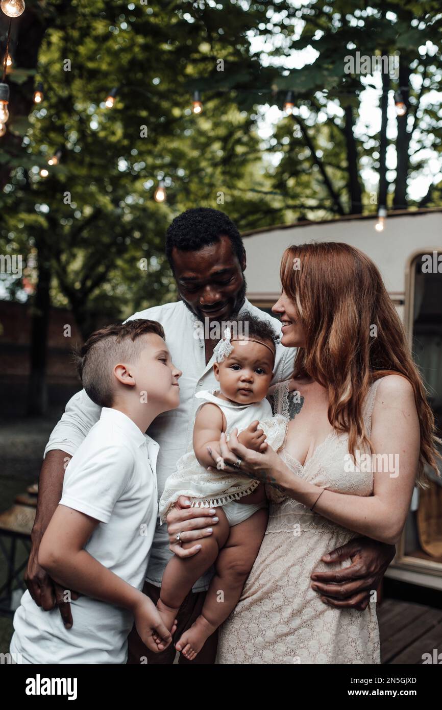 Mixed race family with white son and infant swarthy daughter spend time ...