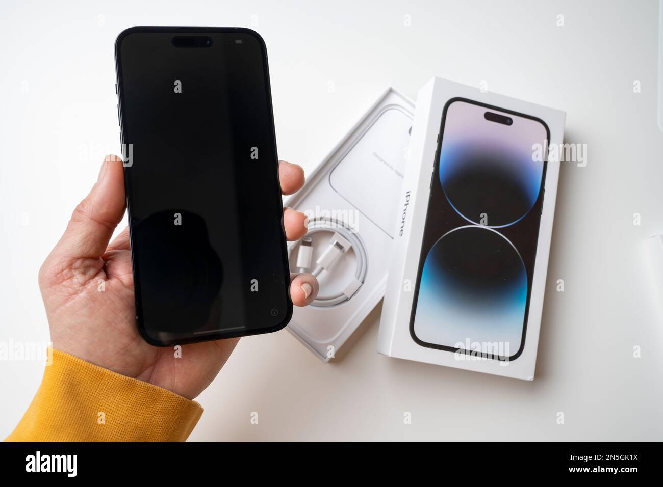 A man holds the latest iPhone 14 Pro Max in Space Black. Apple's latest ...