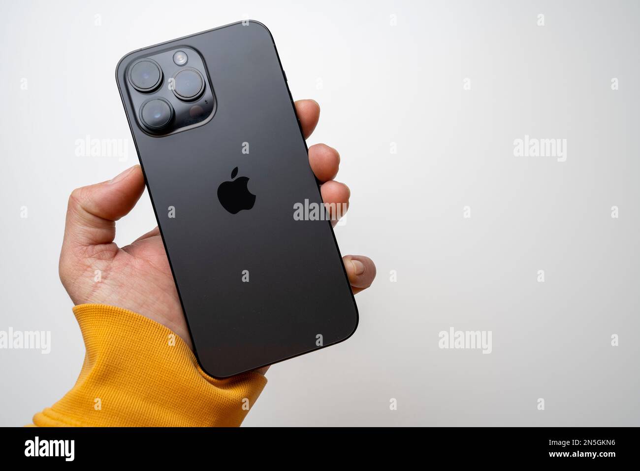 A man holds the latest iPhone 14 Pro Max in Space Black. Apple's latest ...