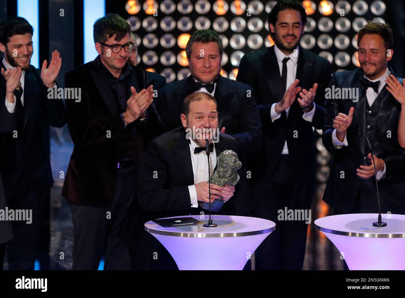 Director Miguel Ferrari, center, holds his Best Foreign Film in the ...