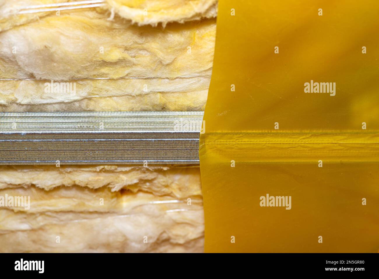 Mounted green plasterboards to an aluminum loft frame, visible yellow ...