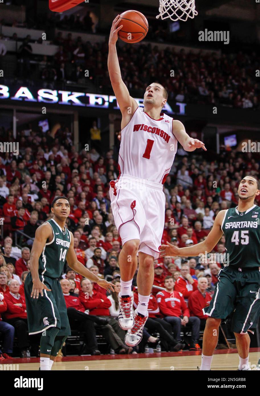 Wisconsin's Ben Brust (1) shoots between Michigan State's Gary Harris ...