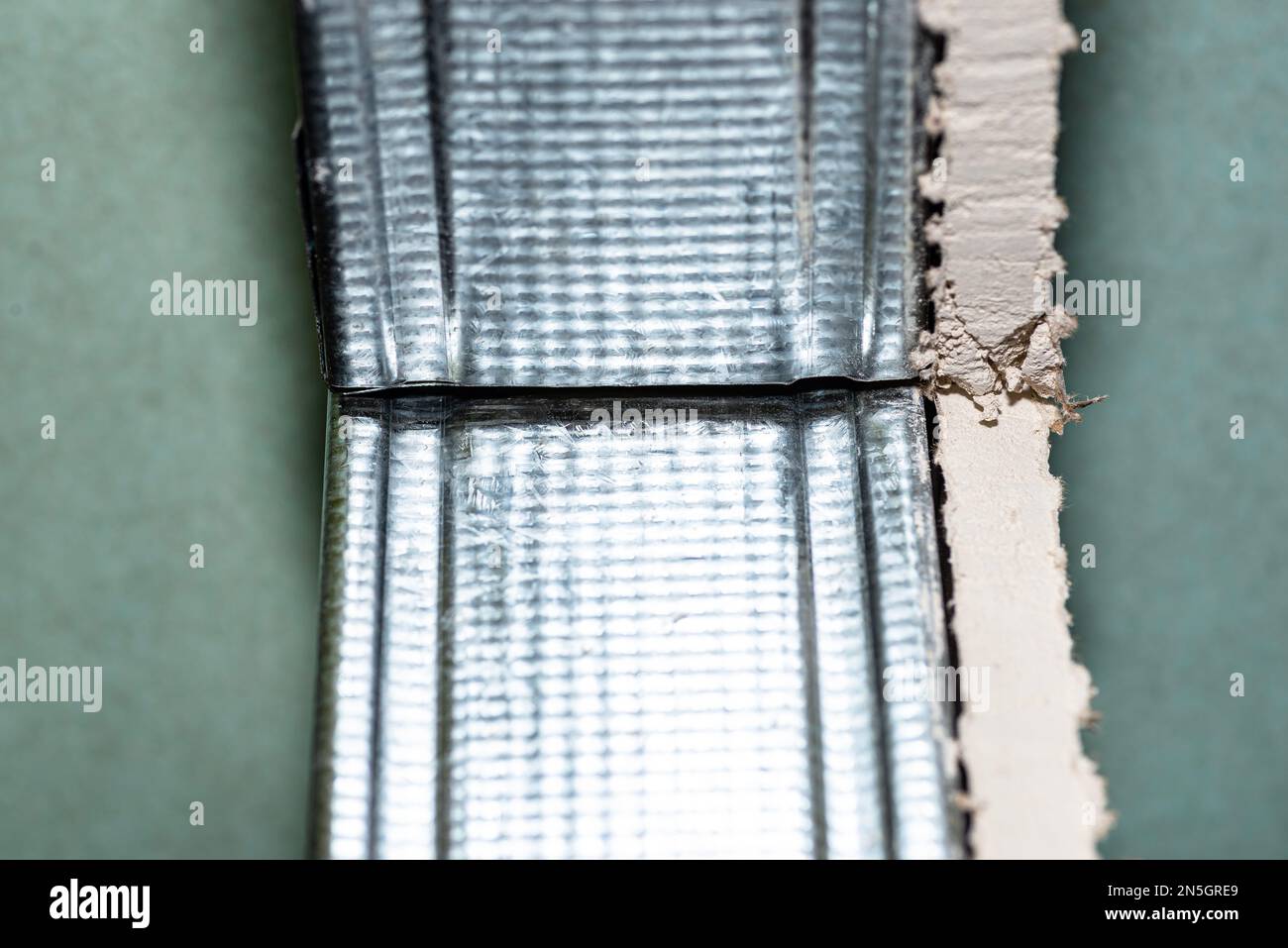 Mounted green plasterboards to an aluminum loft frame, visible black ...