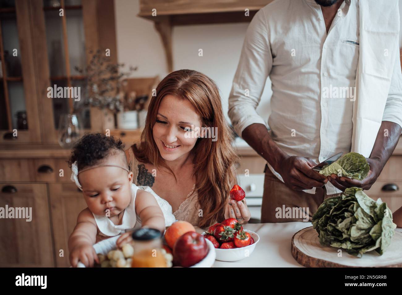 Mixed race family with white son infant swarthy daughter spend time ...