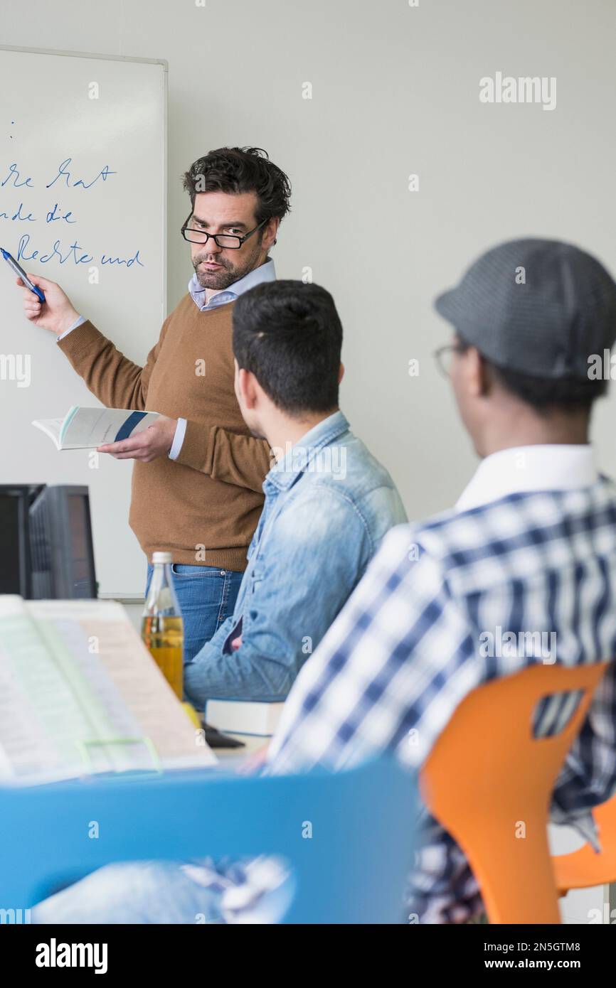 Teacher giving lecture in classroom School, Bavaria, Germany Stock ...