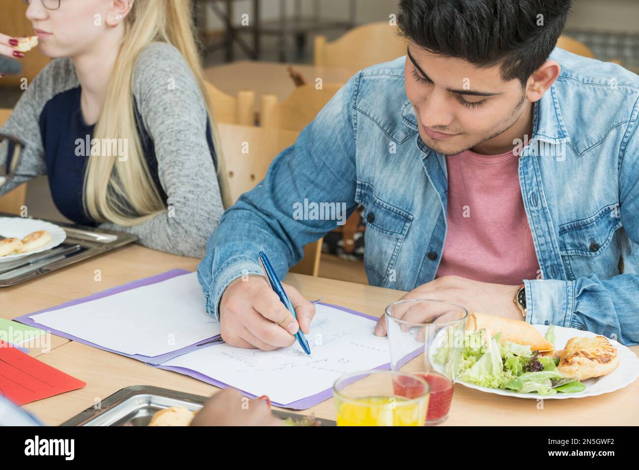 University student studying in canteen and having lunch School, Bavaria ...
