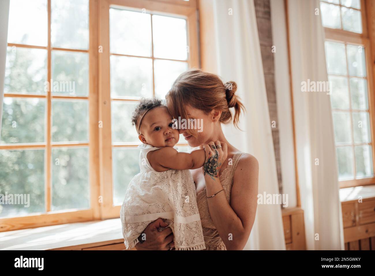Diverse people portrait of mother with swarthy infant spending time at ...