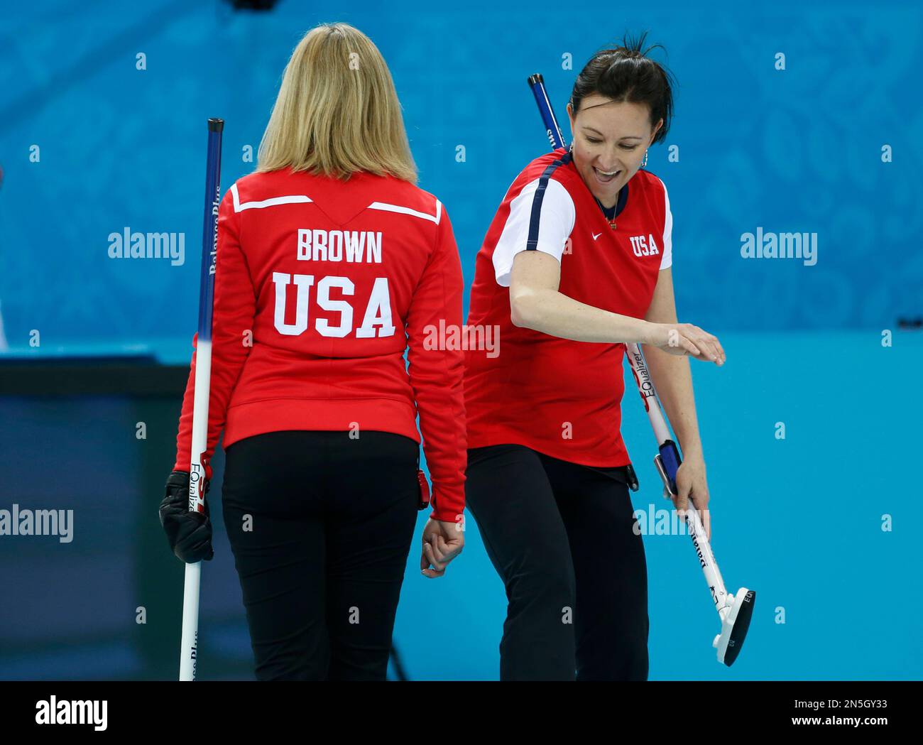 Team USA's Ann Swisshelm, right, pats skip Erika Brown on the behind ...