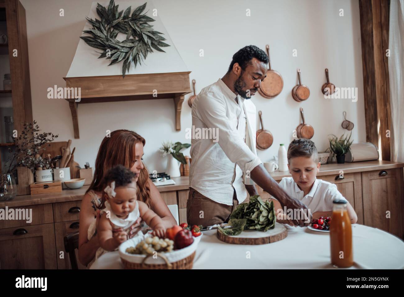 Mixed race family with white son infant swarthy daughter spend time ...