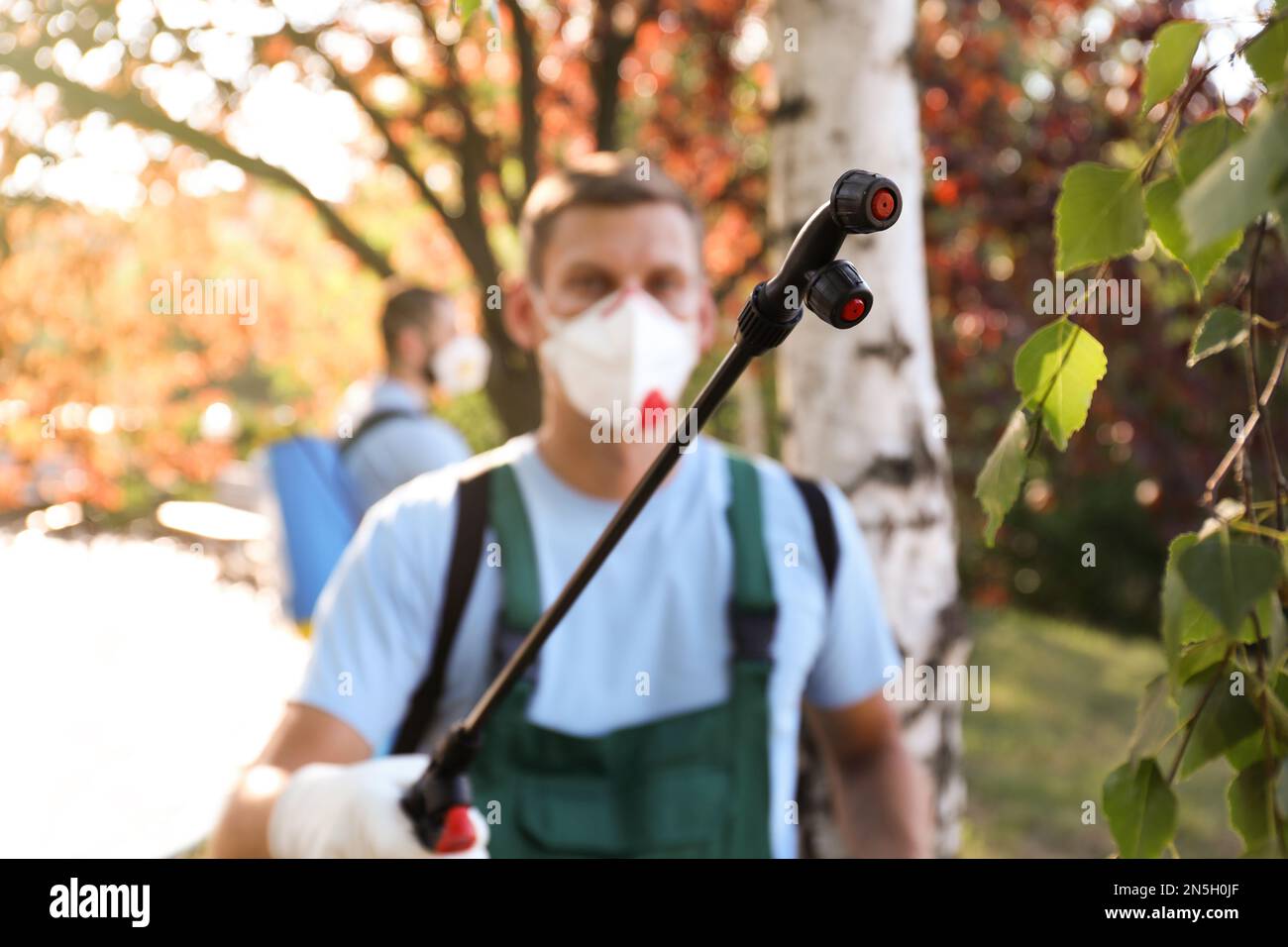 Pest control worker outdoors, focus on insecticide sprayer Stock Photo ...