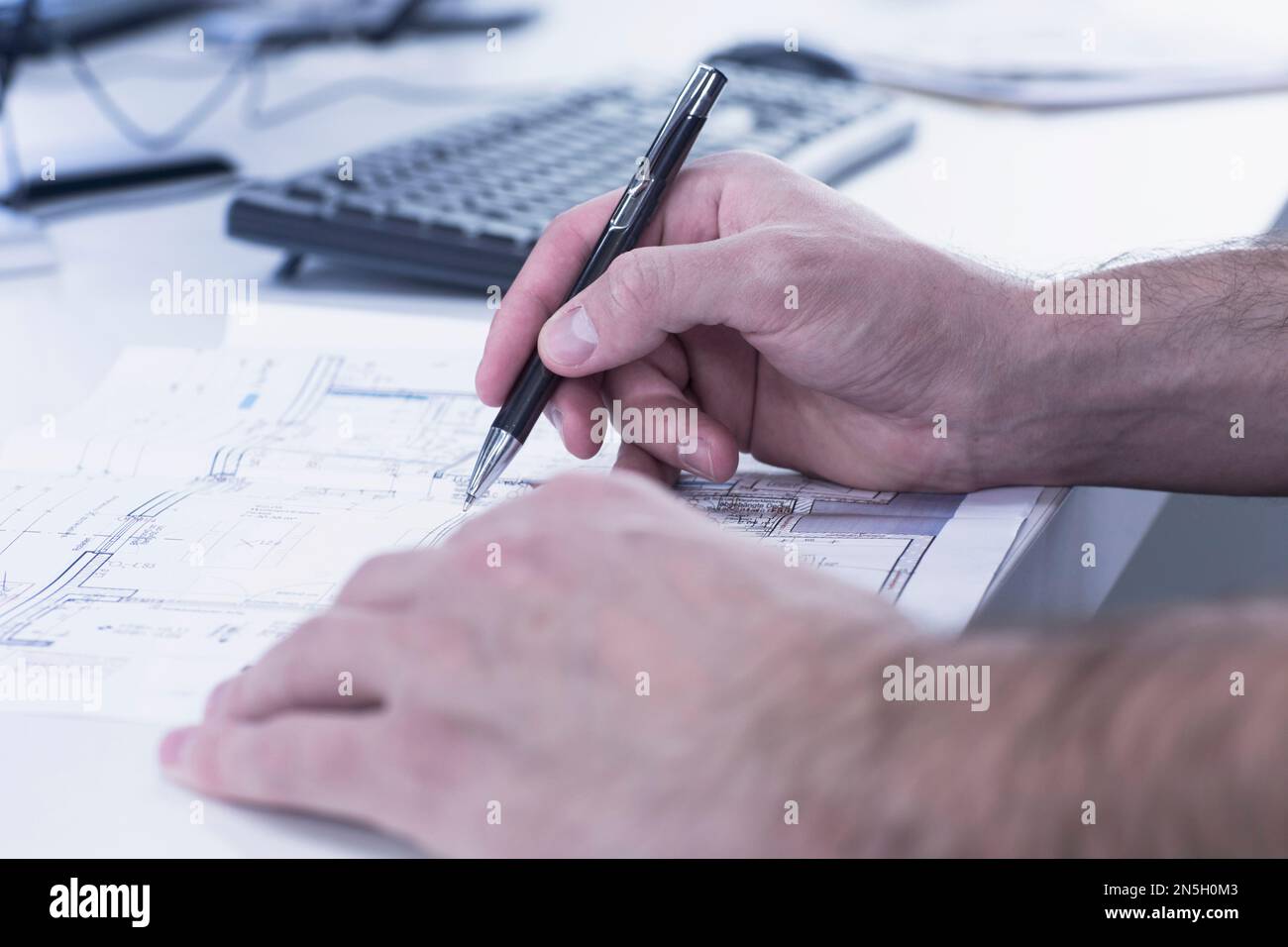 Architect hand drawing blueprint on paper in an office, Freiburg im ...