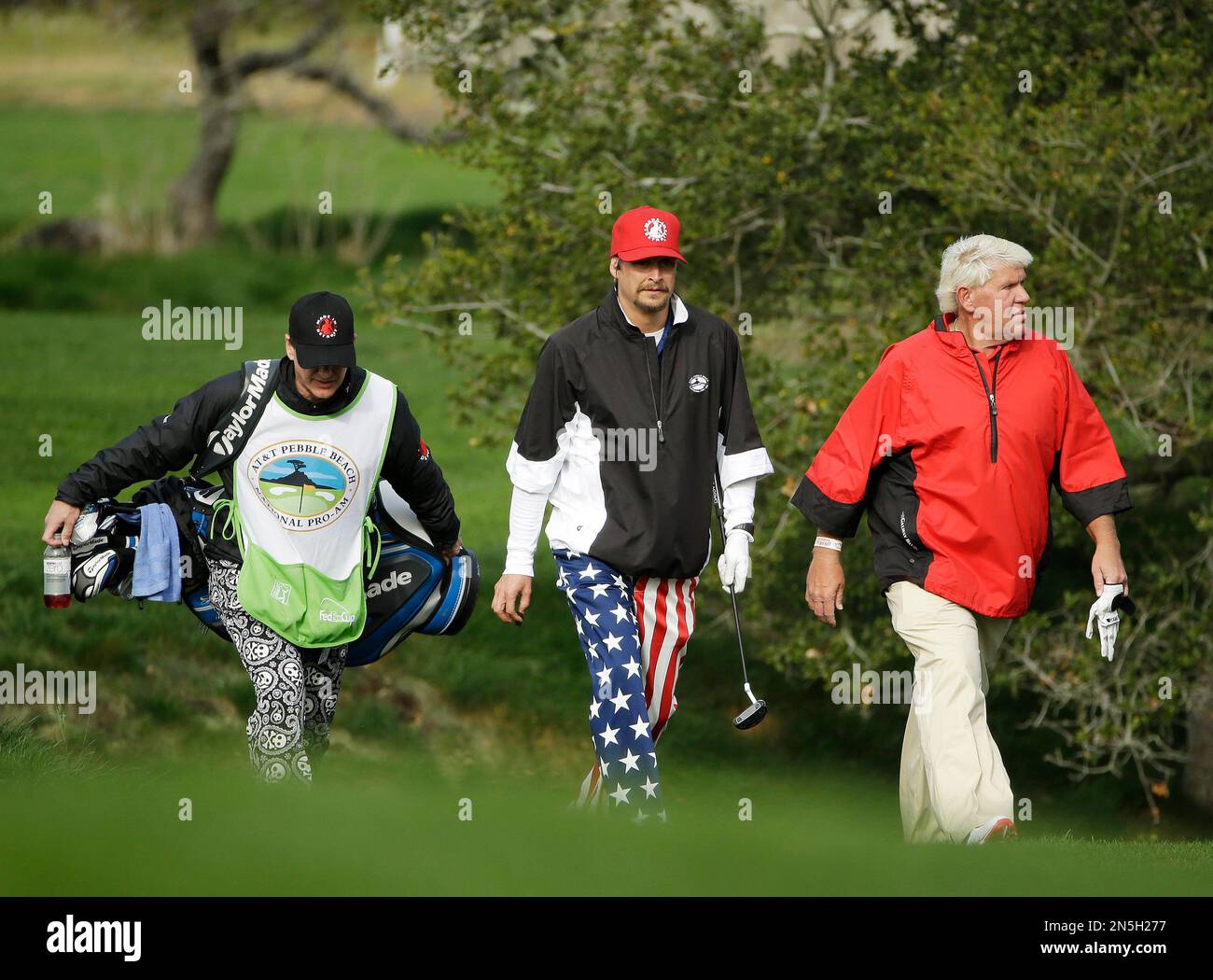 Kid Rock, center, walks with John Daly, right, up to the second green ...