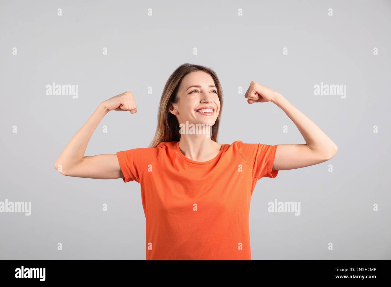 Strong woman as symbol of girl power on light grey background. 8 March ...