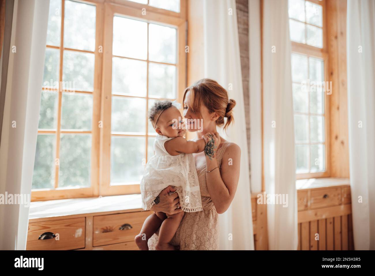 Diverse people portrait of mother with swarthy infant spending time at ...