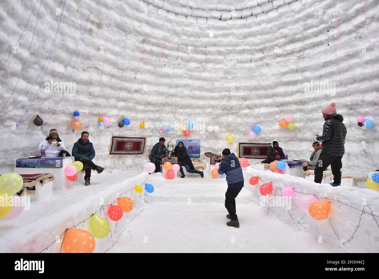Indian tourists take their photos inside an "Igloo Cafe in Ski resort ...