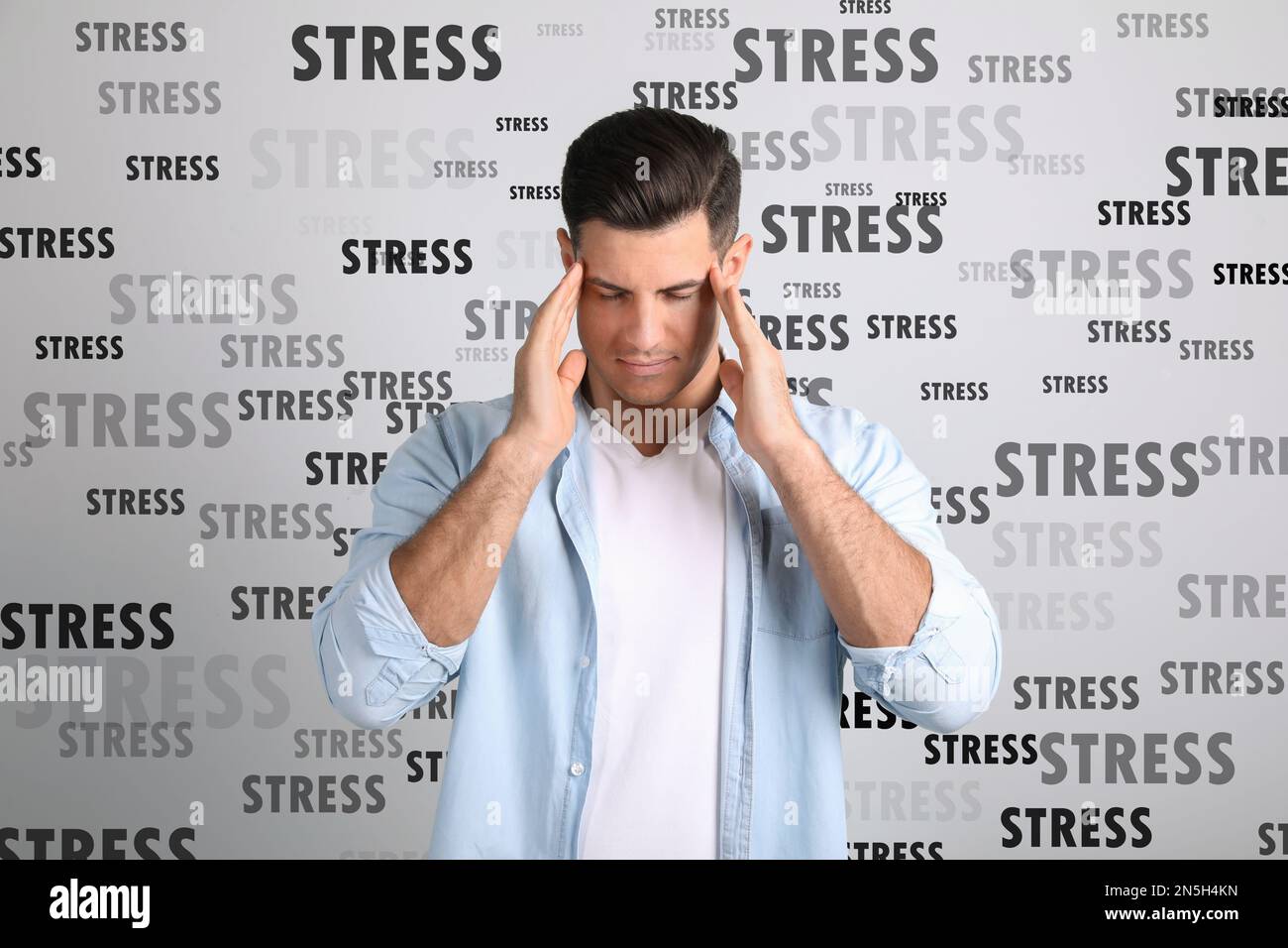 Stressed young man and text on light background Stock Photo - Alamy