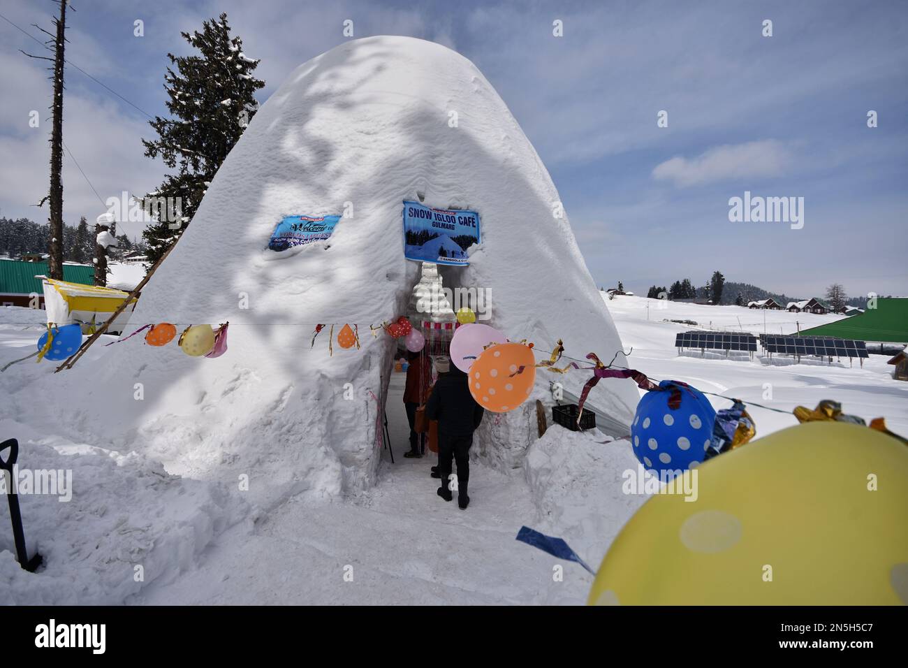 Indian tourist walk out of a Igloo cafe in Ski resort Gulmarg, Indian ...