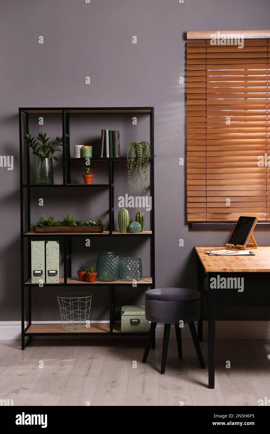 Stylish room with shelving and table. Interior design Stock Photo - Alamy