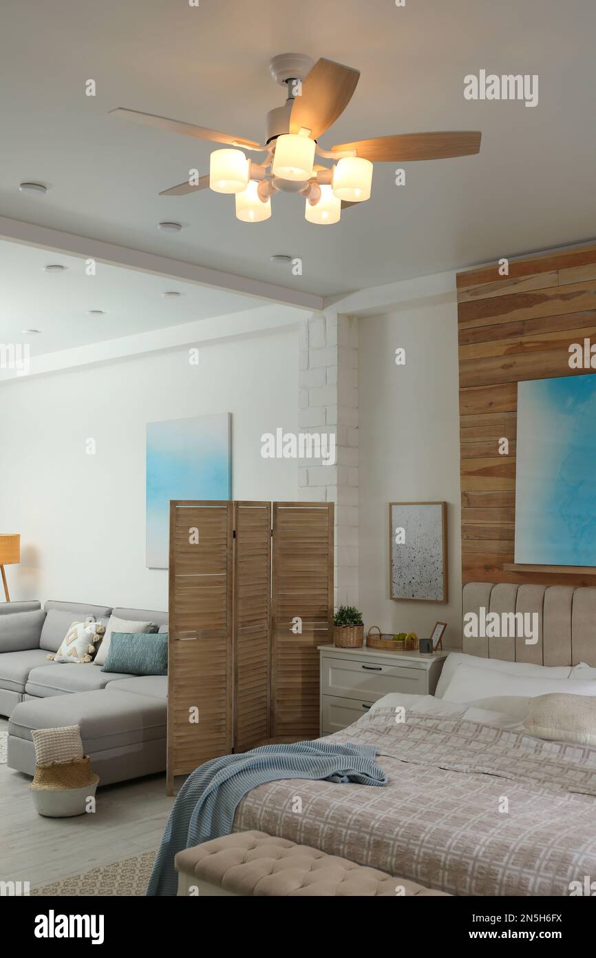 Stylish apartment interior with modern ceiling fan Stock Photo - Alamy