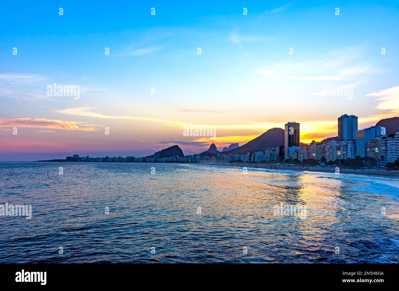 Copacabana beach sunset in Rio de Janeiro with the light coming from ...