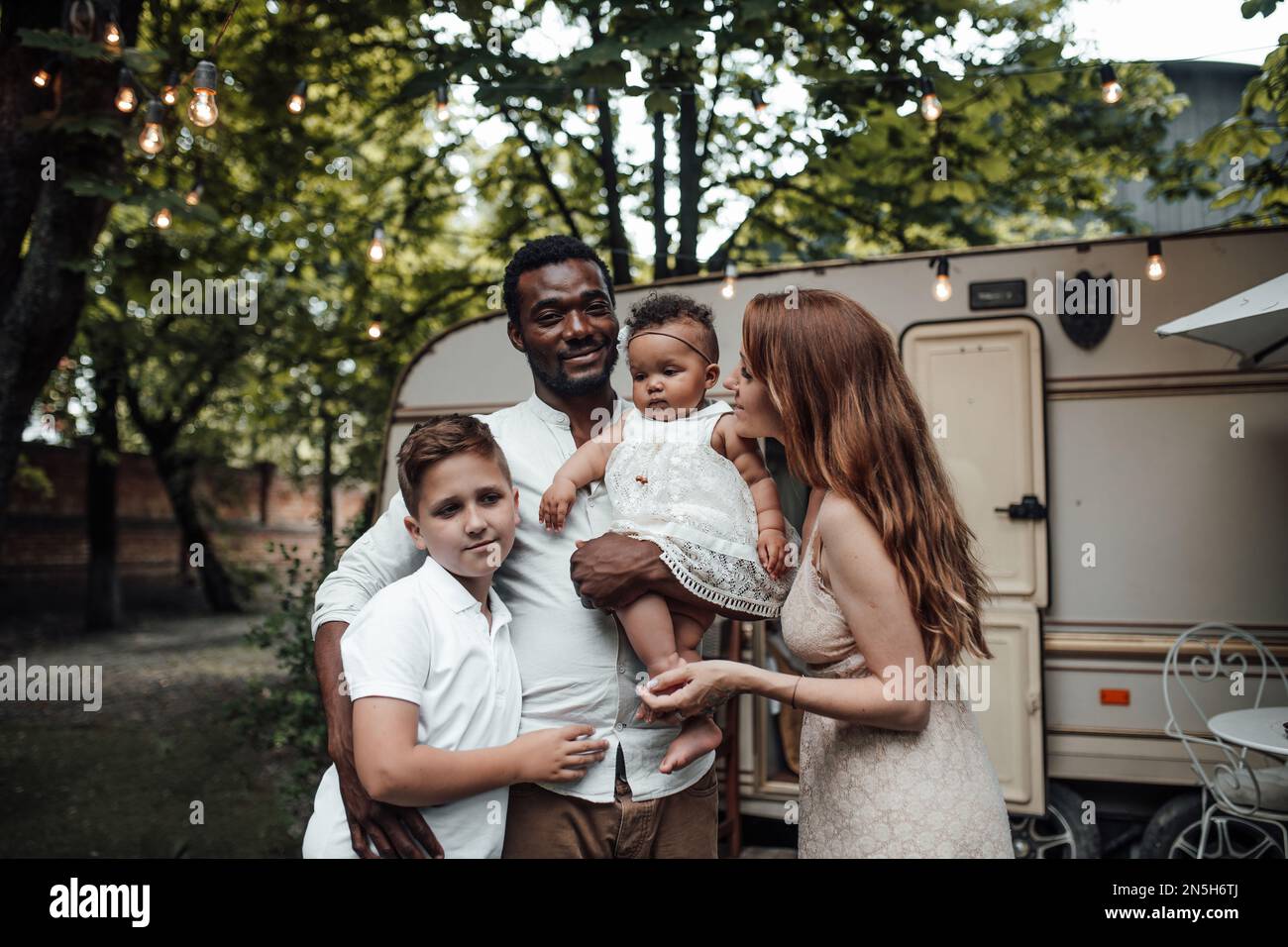 Mixed race family with white son and infant swarthy daughter spend time ...