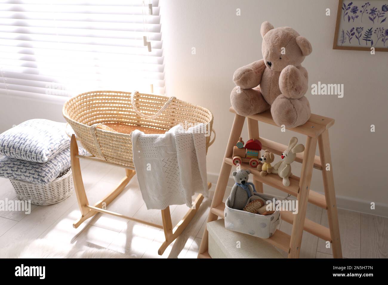 Decorative ladder with toys and different stuff in stylish baby room ...