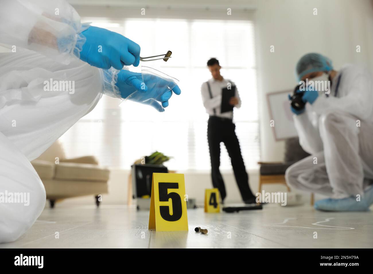 Investigators working at crime scene in messy room, closeup Stock Photo ...