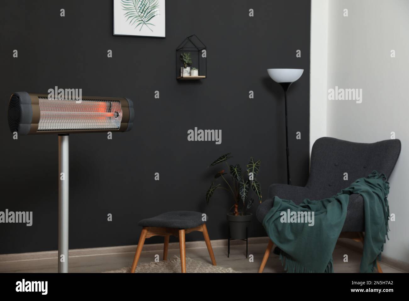 Modern electric infrared heater in room interior Stock Photo - Alamy