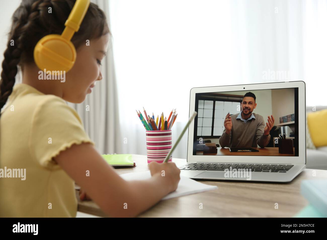 Distance learning, studying at home. Girl having online school lesson ...