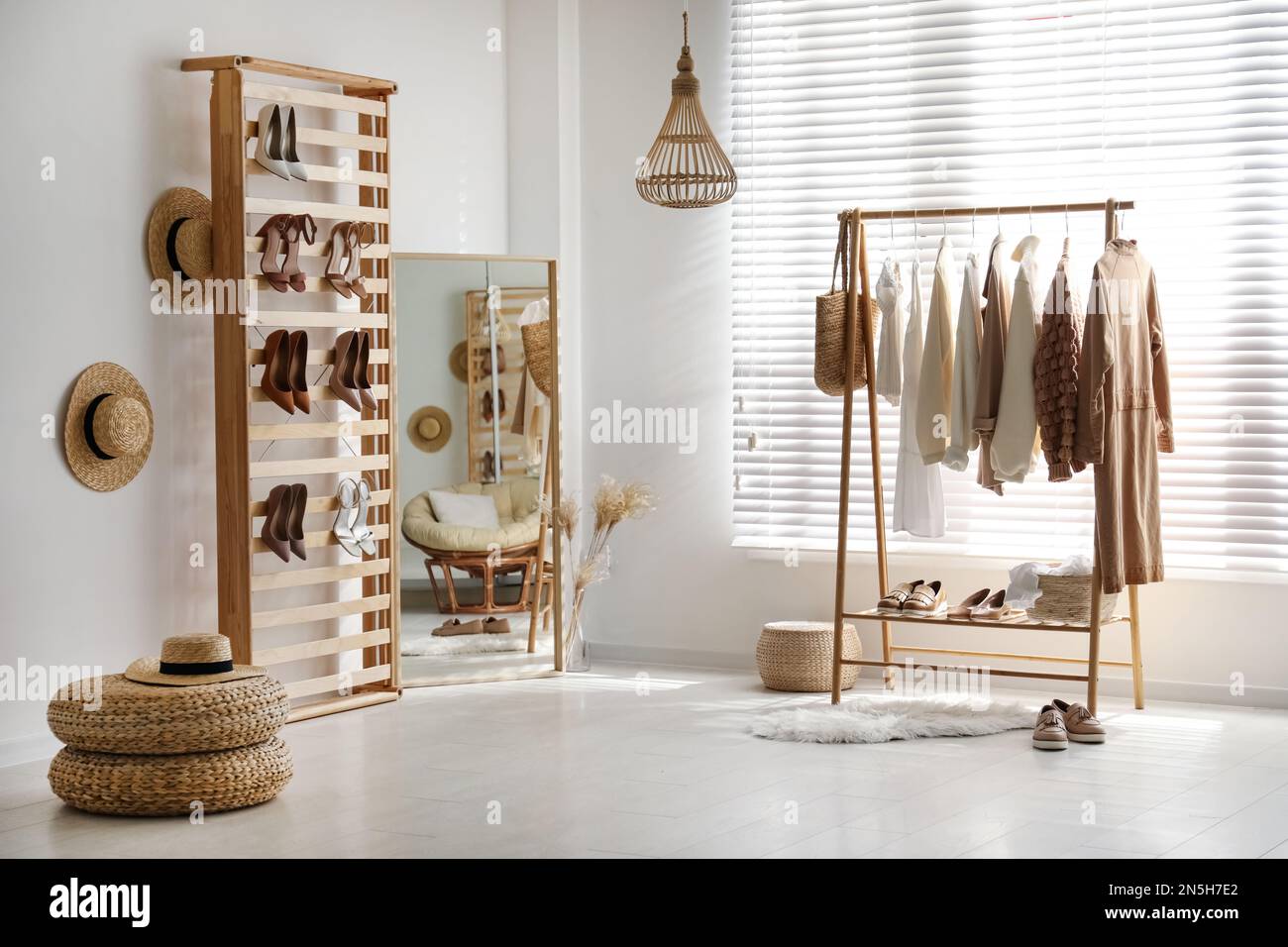 Modern dressing room interior with racks of stylish women's clothes and ...