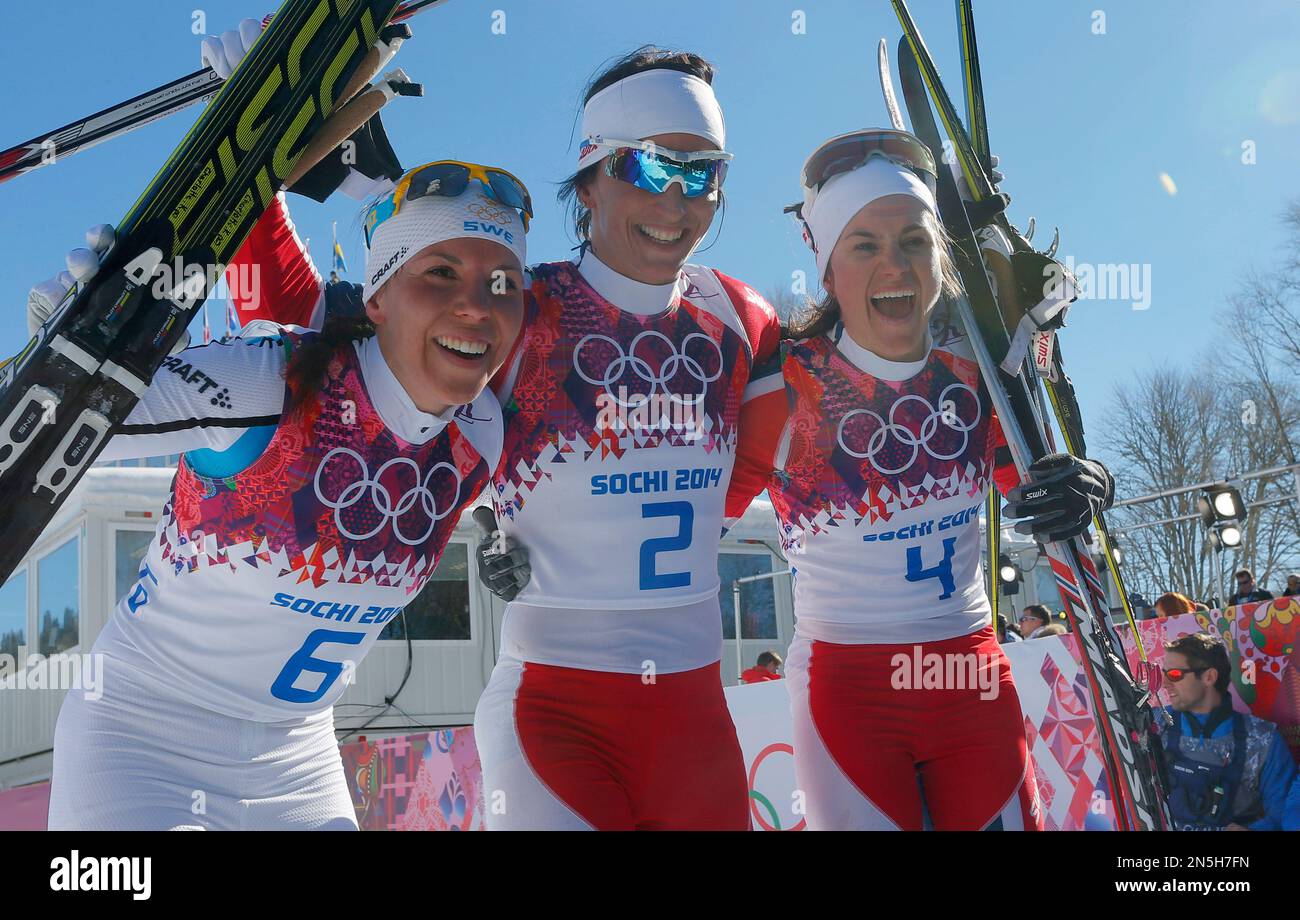 Norway's gold medal winner Marit Bjoergen is flanked by Sweden's silver ...