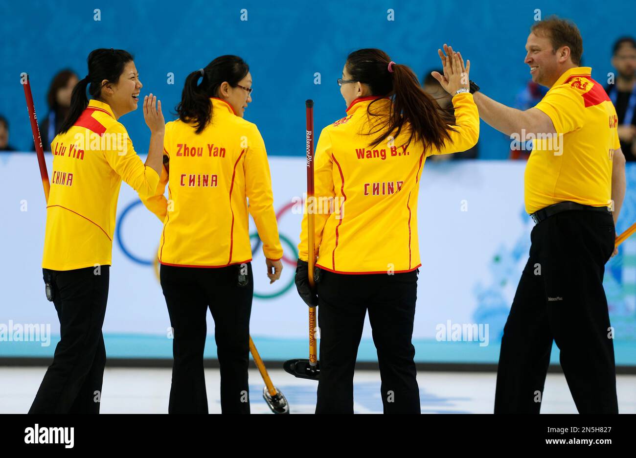 Team China coach Marcel Rocque of Canada congratulates his players ...