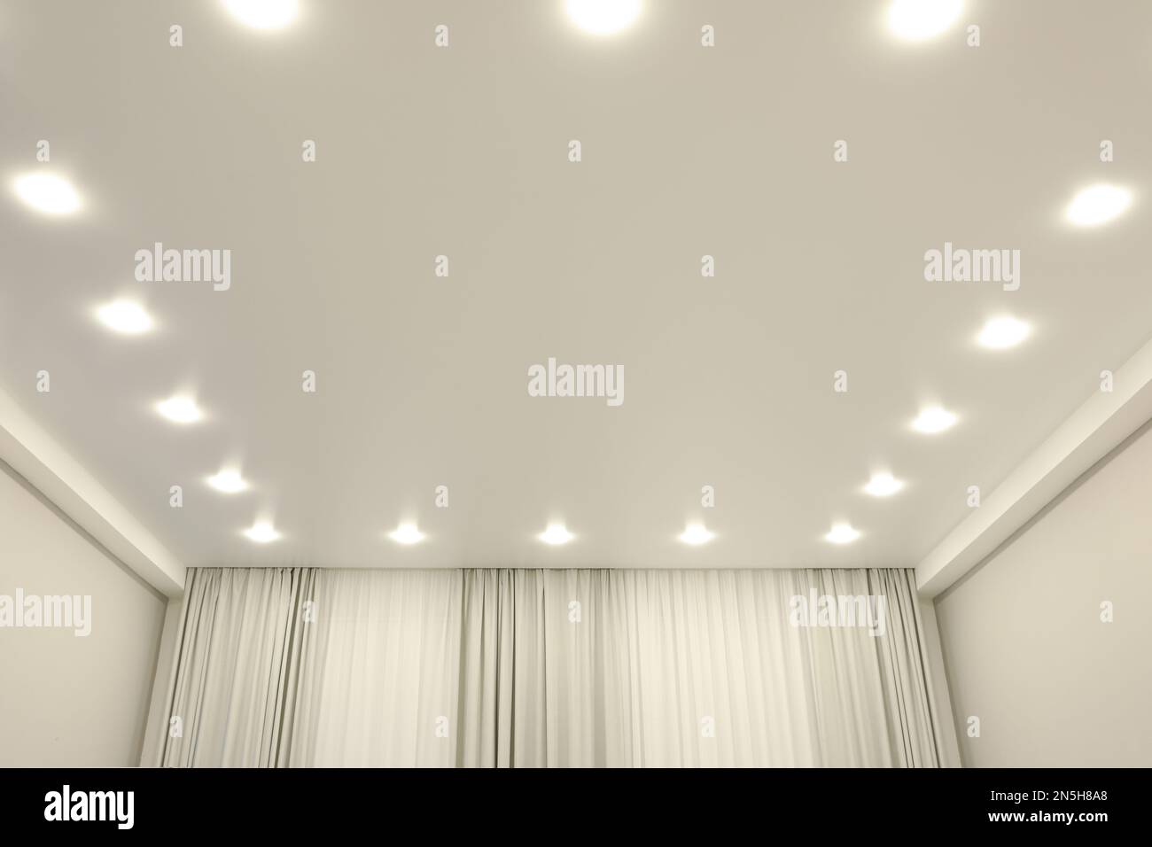 White stretch ceiling with spot lights in room Stock Photo - Alamy