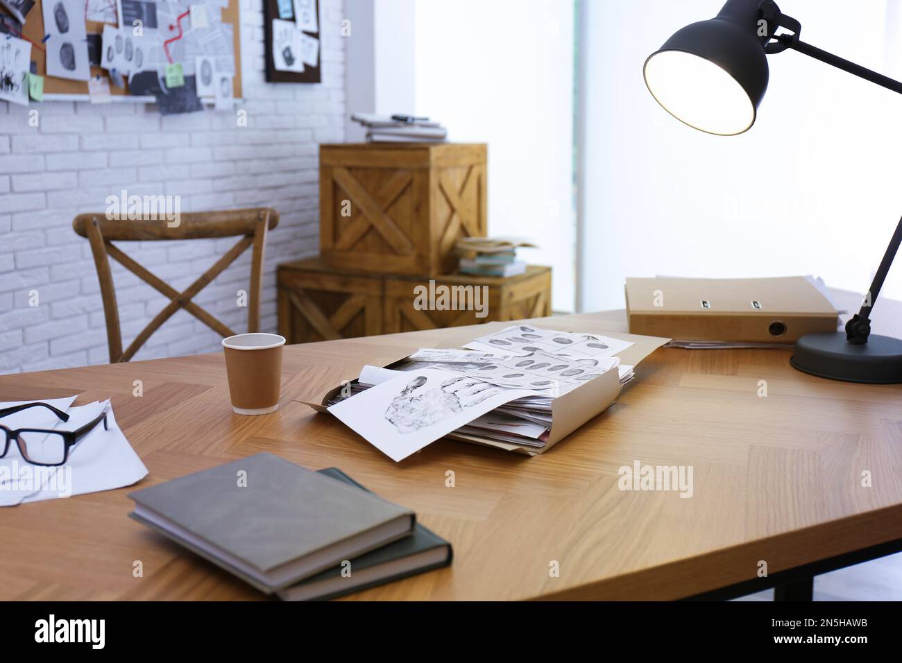Detective workplace with documents and coffee in office Stock Photo - Alamy
