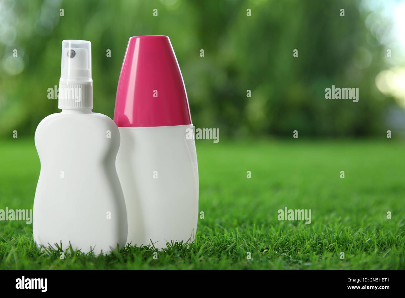 Different insect repellents on green grass. Space for text Stock Photo ...