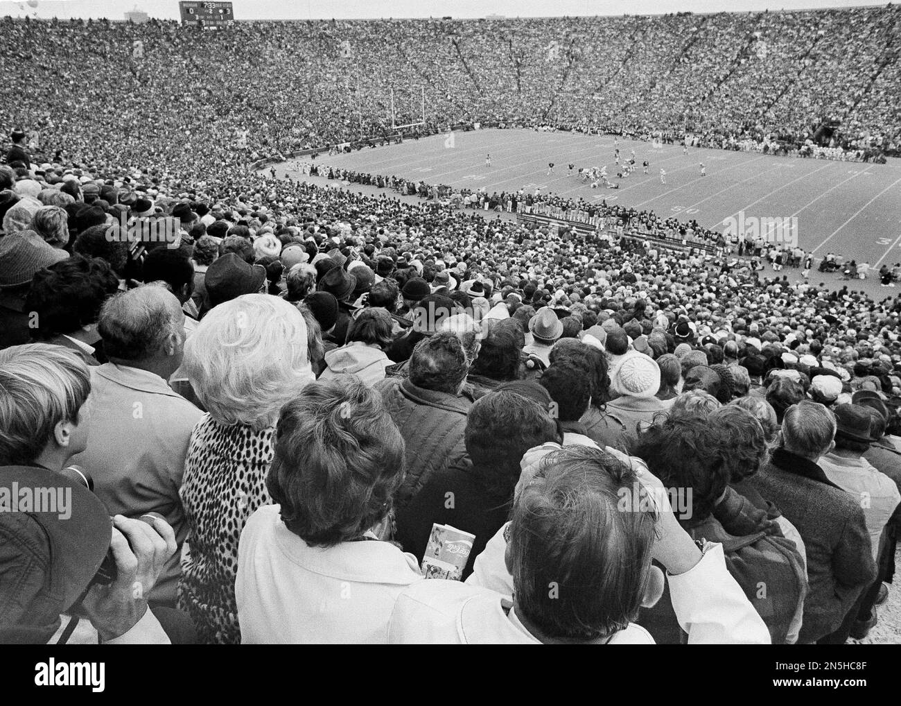 A crowd of 105,223 football fans crowd the Michigan Stadium to watch ...