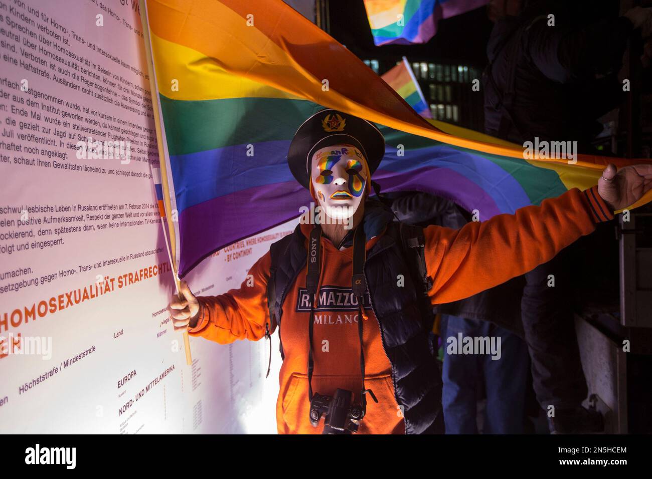 An activist with poses with the rainbow flag during the Rainbow Flame ...