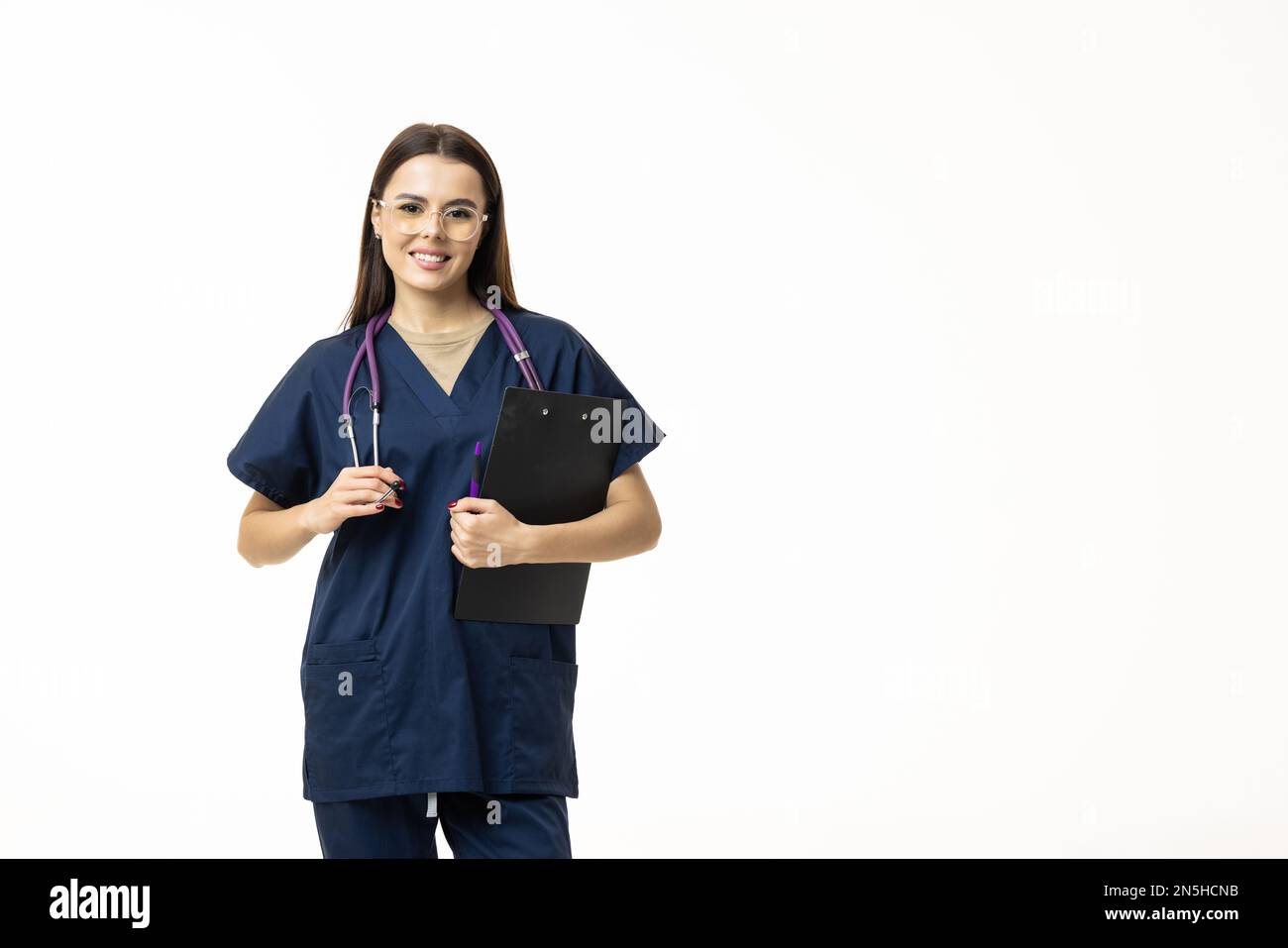 Side view of the smiling female doctor in lab coat with arms crossed ...