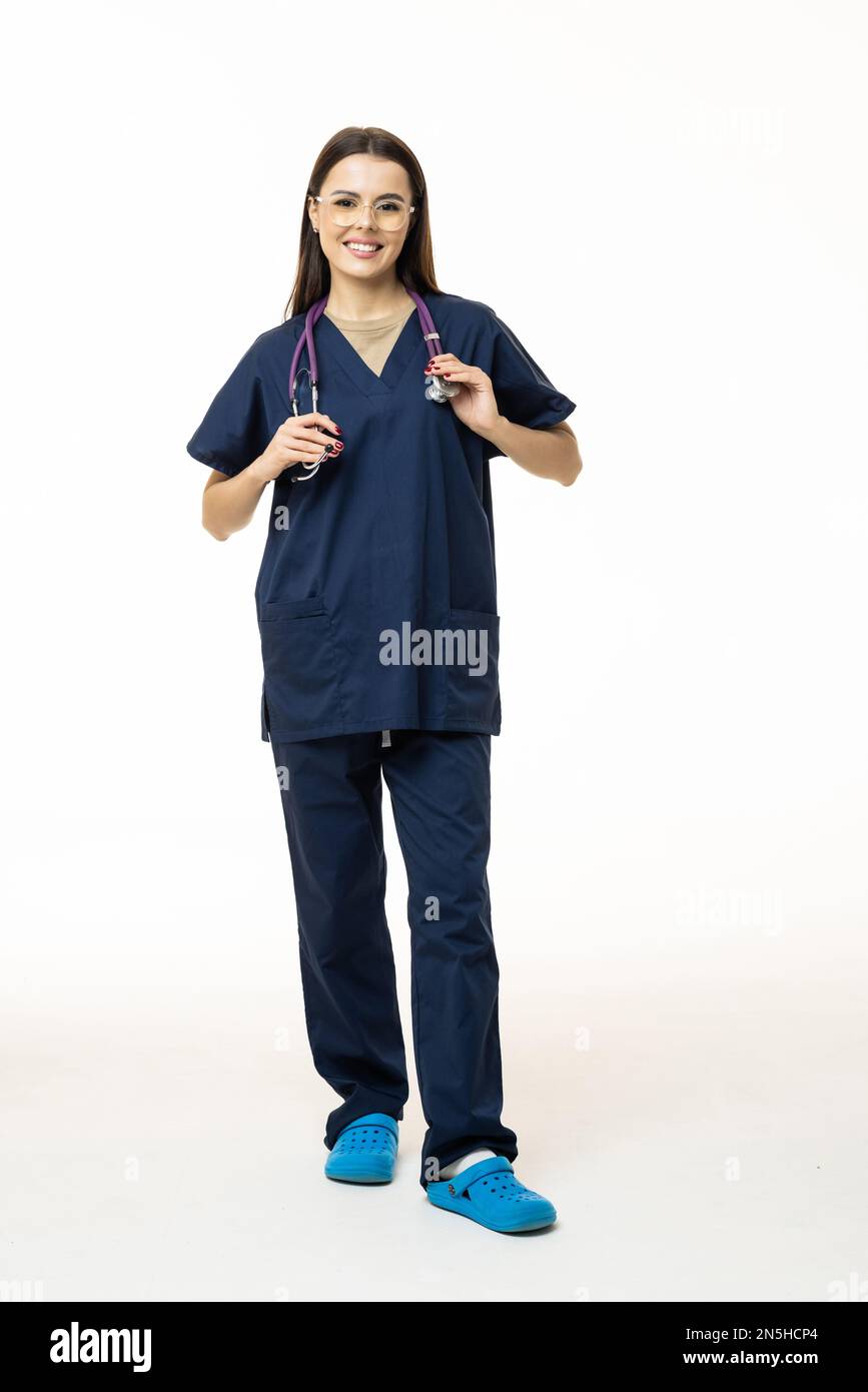 Side view of the smiling female doctor in lab coat with arms crossed ...