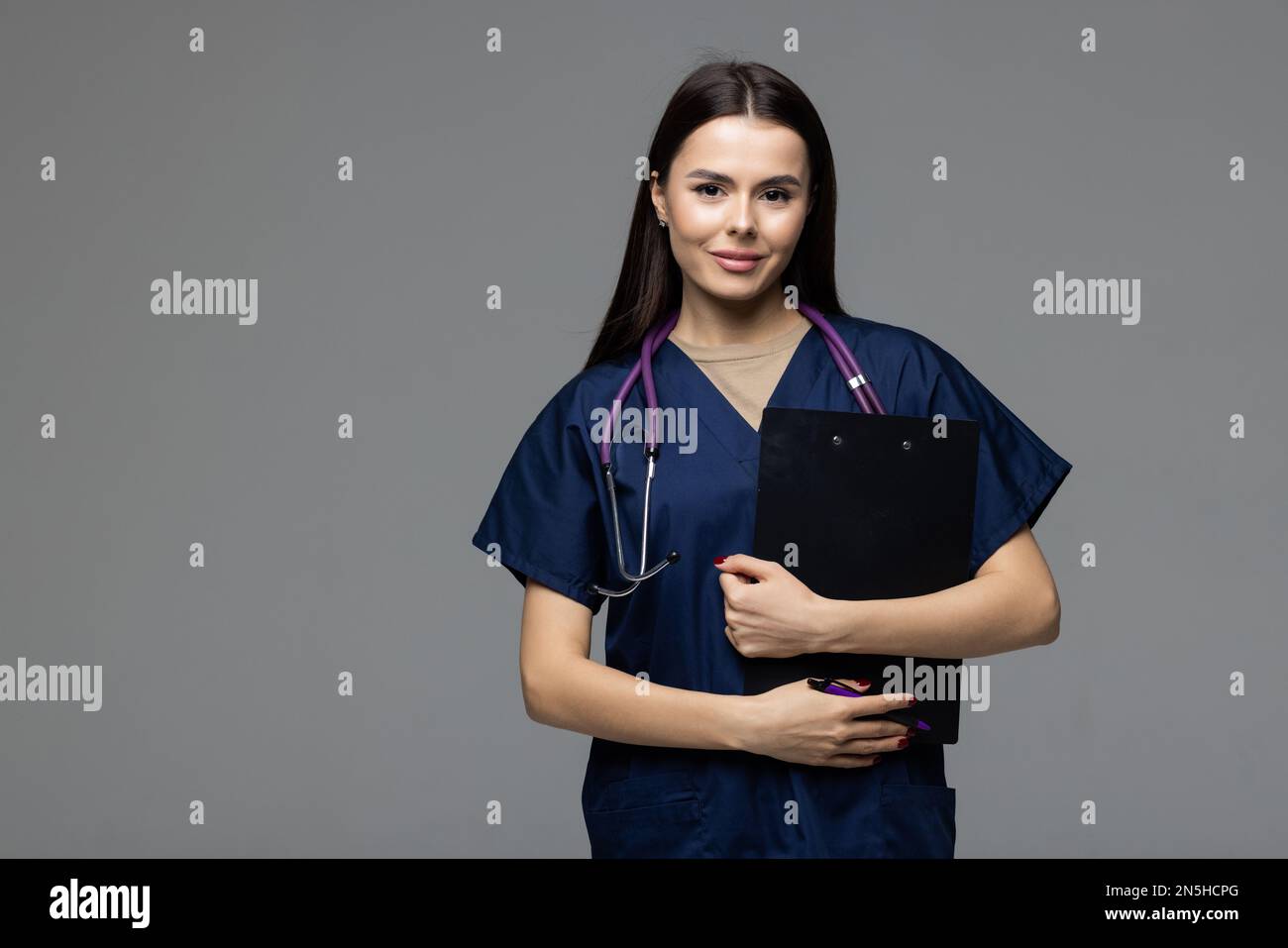Female medical assistant with folder on white background Stock Photo ...