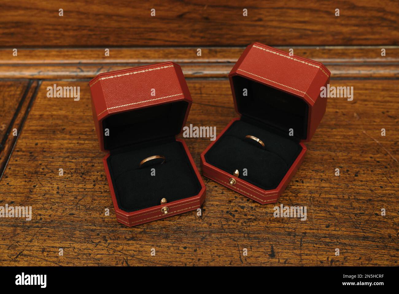 Golden wedding rings in Cartier ring box Stock Photo - Alamy