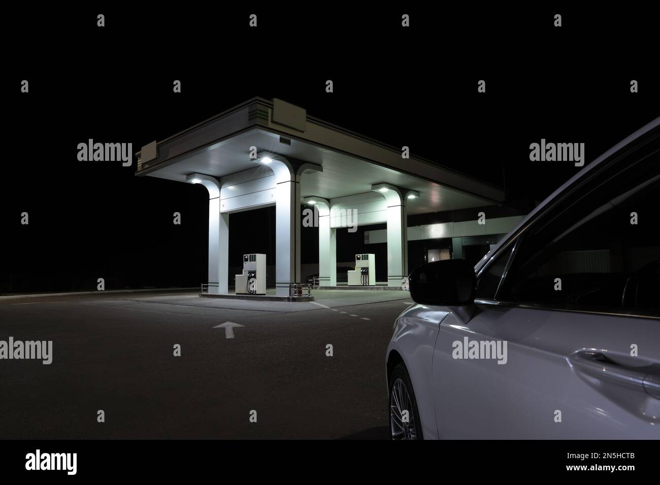 Modern car driving to gas station at night, closeup Stock Photo - Alamy