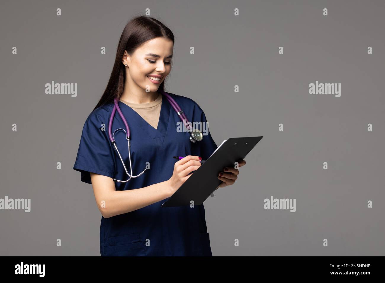 Female medical assistant with folder on white background Stock Photo ...