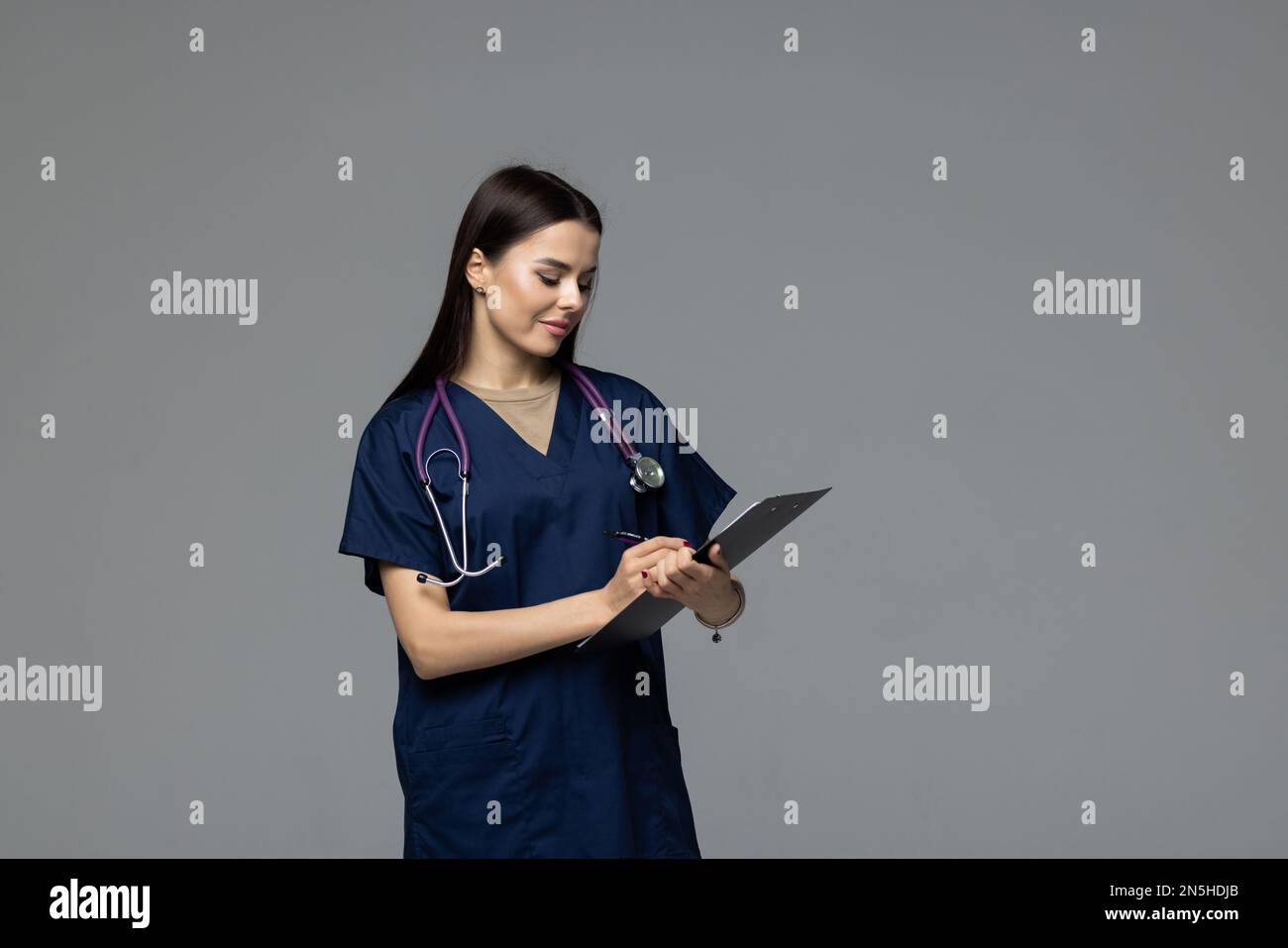 Female medical assistant with folder on white background Stock Photo ...