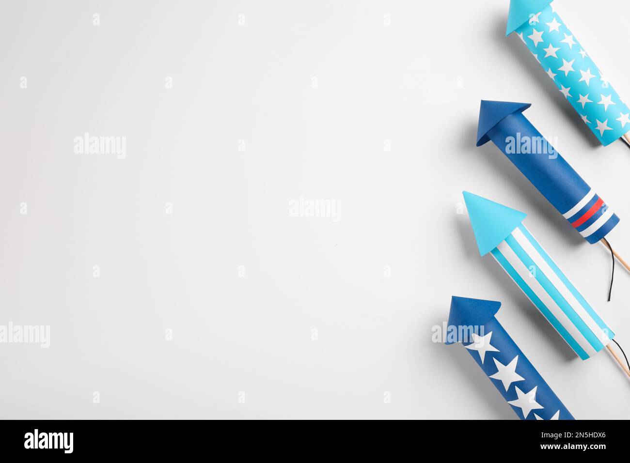 Firework rockets on white background, flat lay. Space for text Stock ...