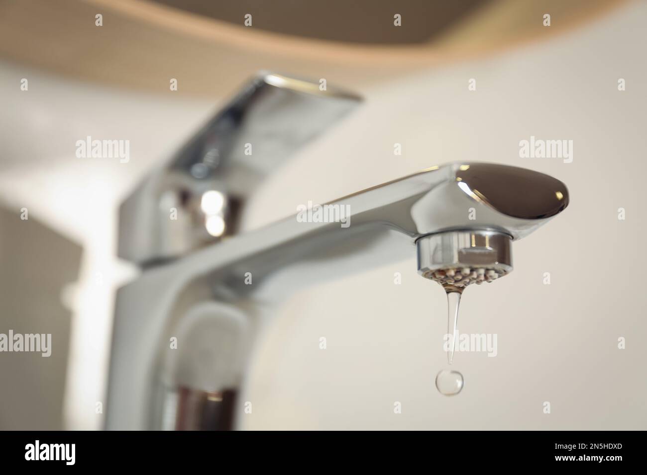 Water drop falling down from tap on blurred background, closeup Stock ...